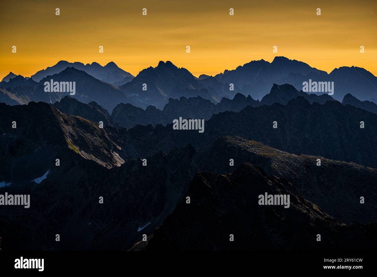 Dark silhouettes of the High tatras from the Mount Krivan at sunrise ...