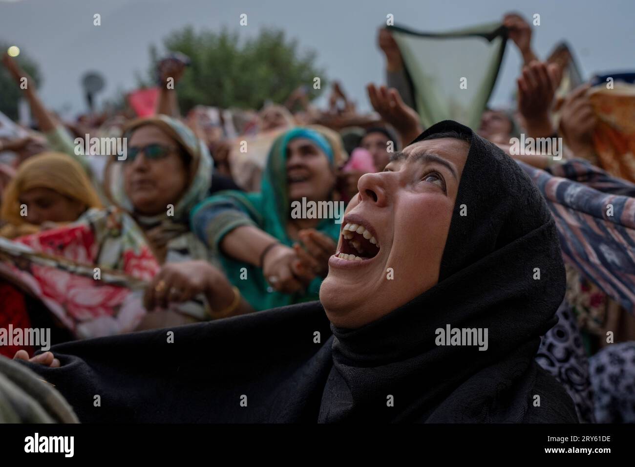 A Kashmiri Muslim prays as a head priest displays a relic, believed to ...