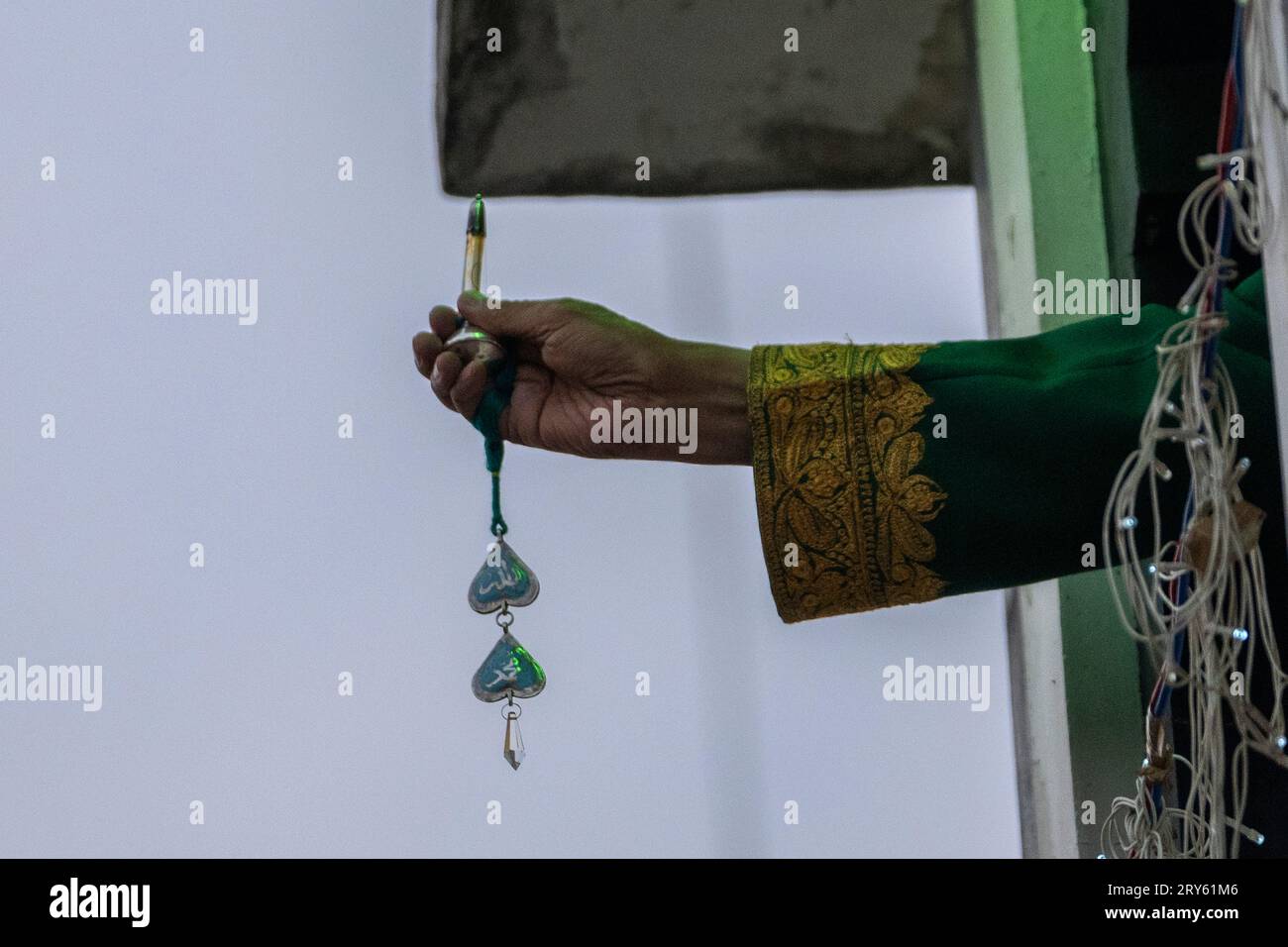 A head priest displays a relic, believed to be a hair from the beard of ...