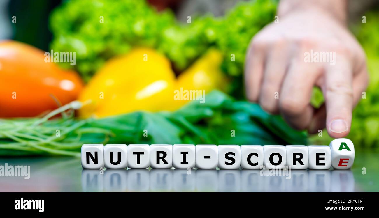 Hand turns dice and changes the Nutri-score from E to A. Symbol for a ...