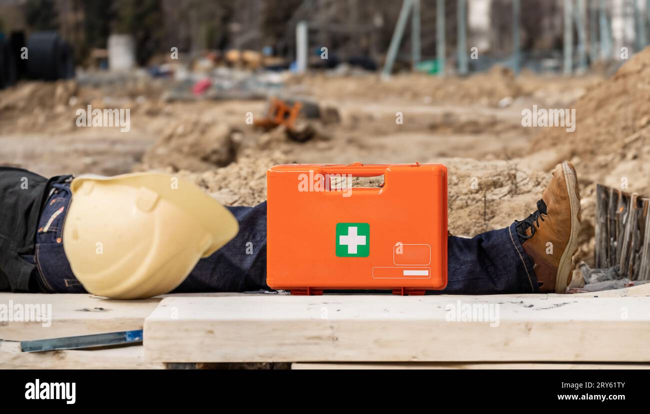 Symbol for an work accident. Man lies on the ground next to a first aid ...