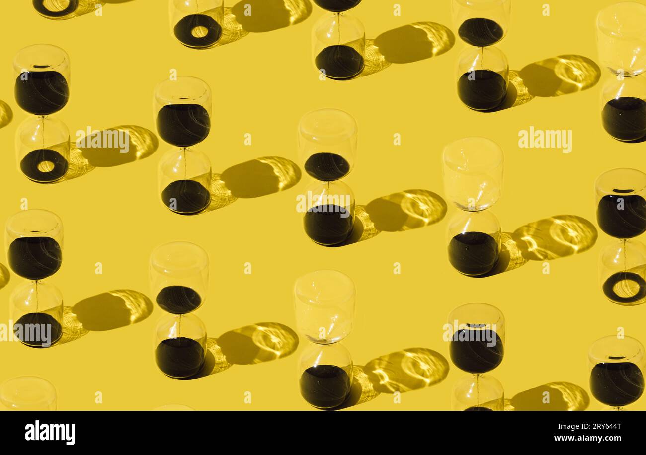 Pattern made of hourglass on yellow background. Creative hourglass ...