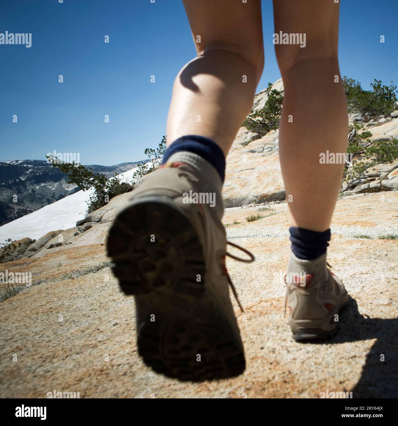 Legs and feet of a female hiker going uphill Stock Photo - Alamy