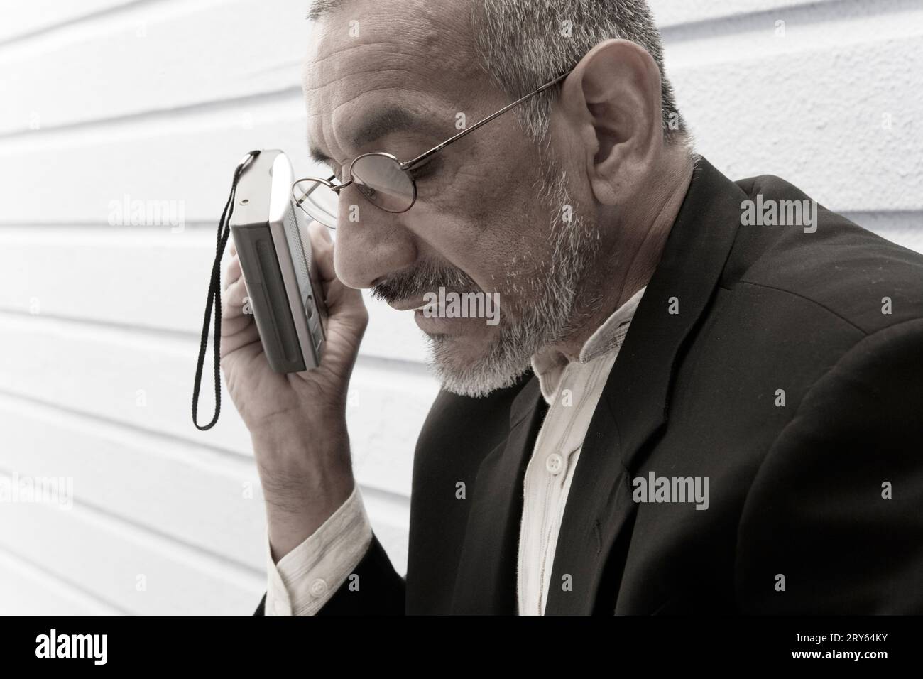 A man with a electronic device in his hand Stock Photo - Alamy