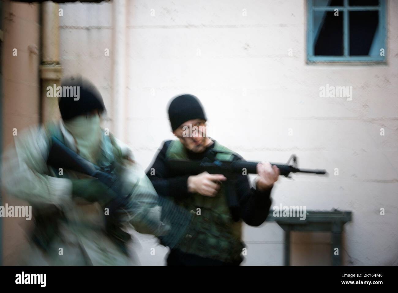 Two soldiers pointing guns Stock Photo - Alamy