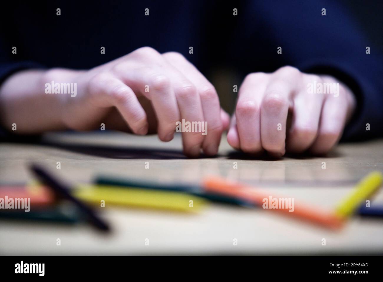 A childs hands and crayons Stock Photo - Alamy
