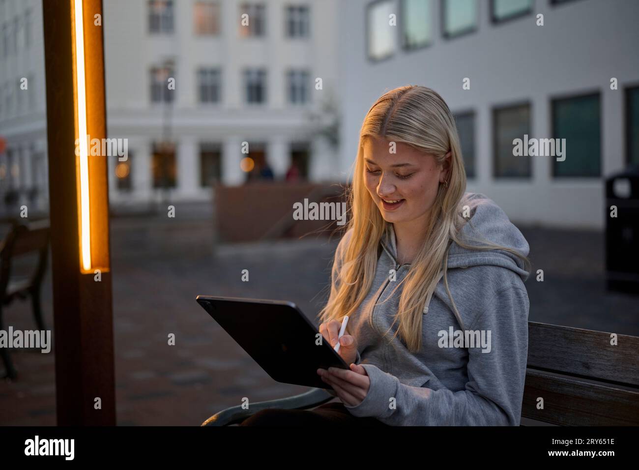 Positive young female illustrator drawing sketch on tablet Stock Photo ...