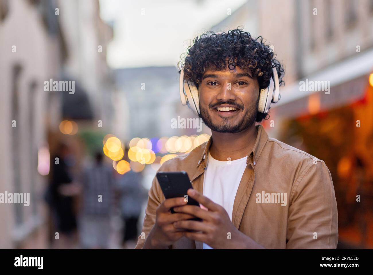 Portrait of a handsome smiling Indian man looking at the camera ...