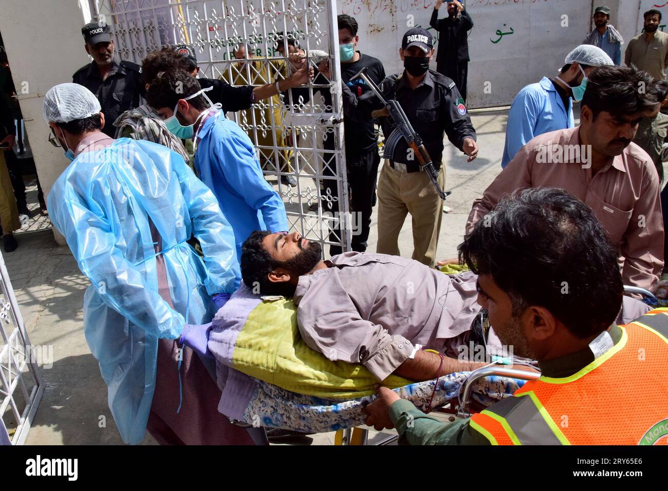 Paramedics and volunteers transport an injured victim of a bomb ...