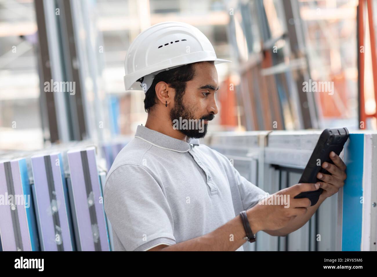 engineer with helmet working in a house construction site Stock Photo ...