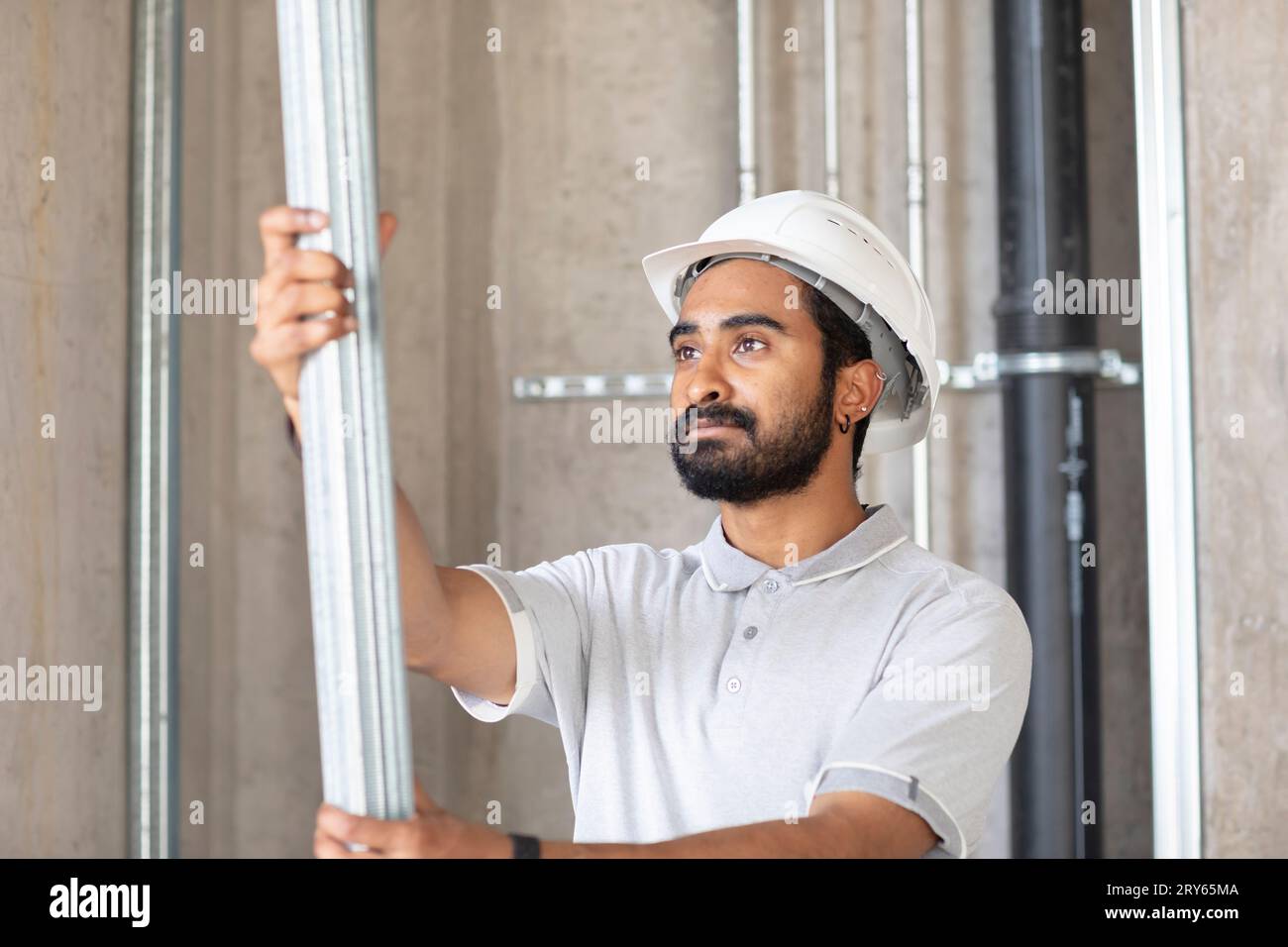 engineer with helmet working in a house construction site Stock Photo ...