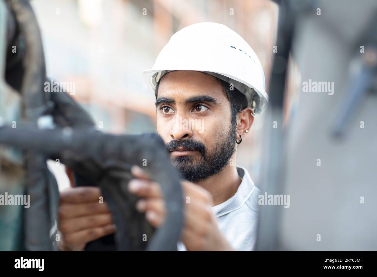 engineer with helmet working outside Stock Photo - Alamy
