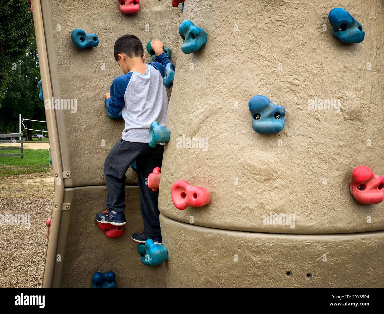 Boy on playground climbing wall hi-res stock photography and images - Alamy