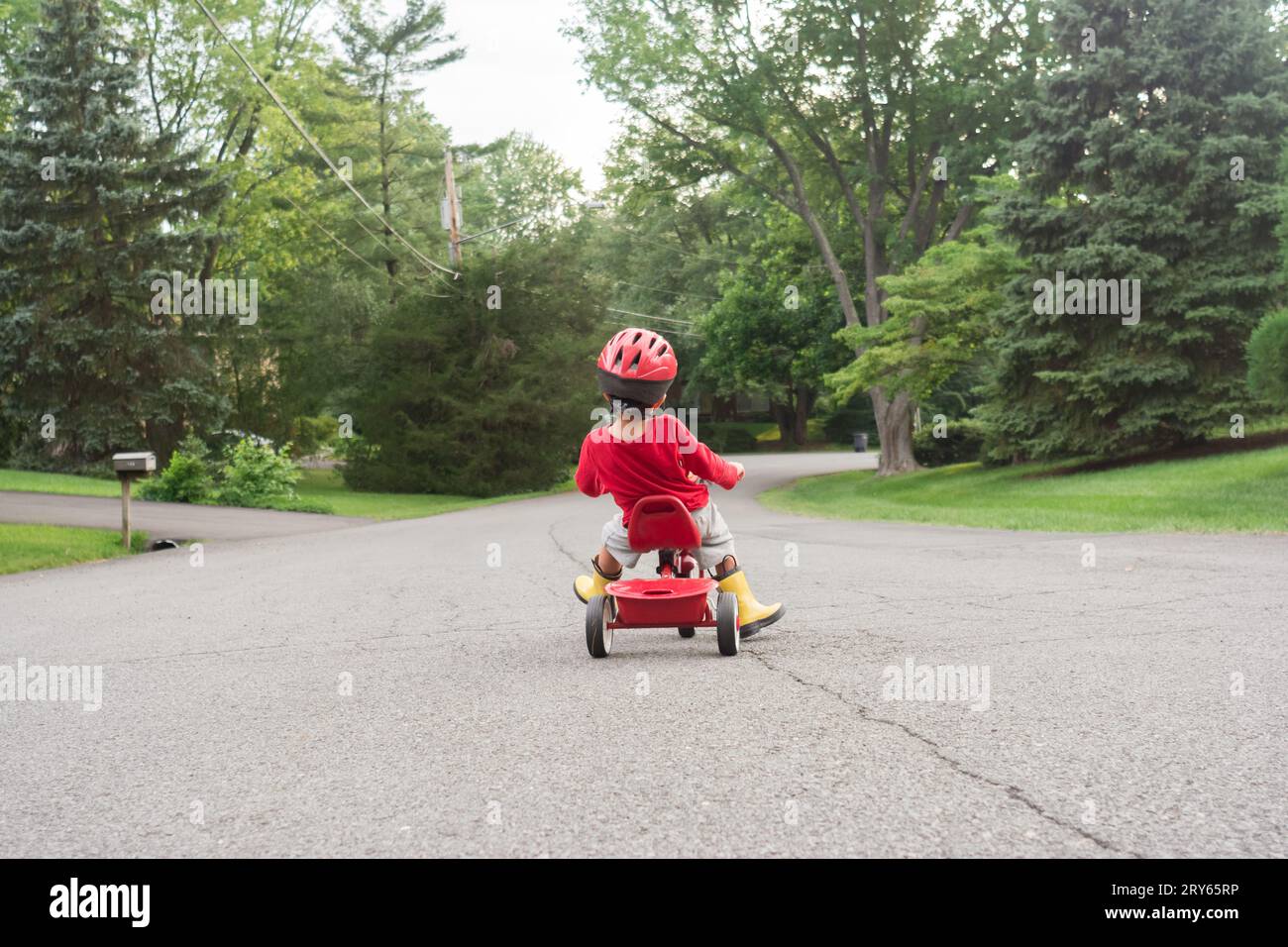 Happy child riding tricycle hi-res stock photography and images - Alamy