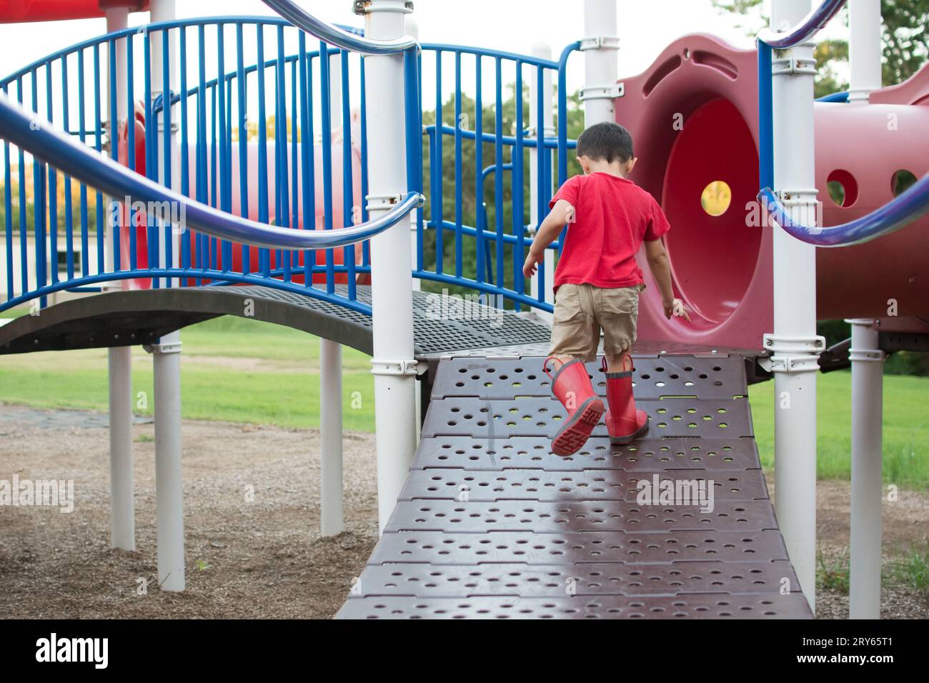 Young boy playing in suburban playground Stock Photo - Alamy