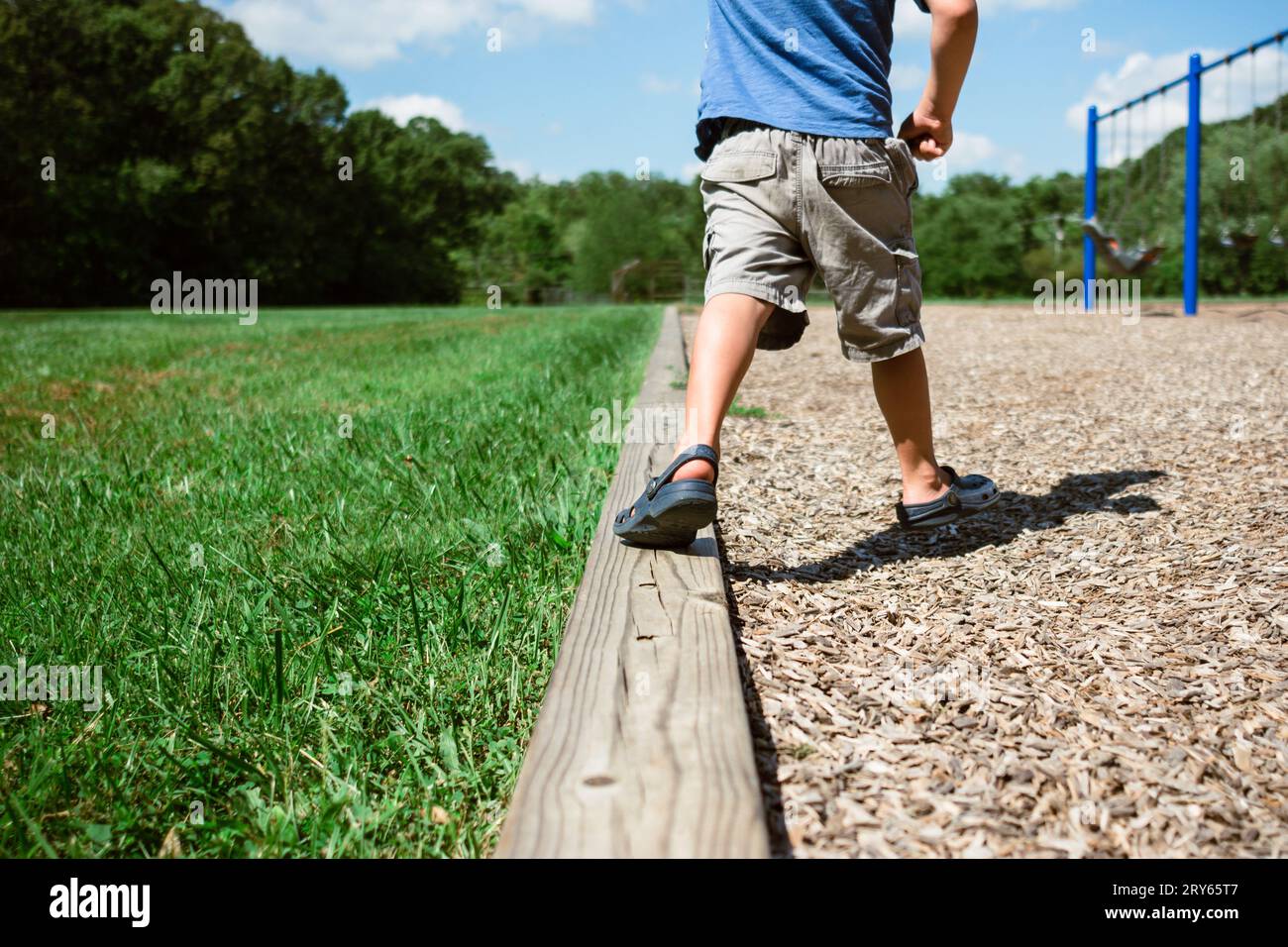 Cropped photograph of young boy playing in suburban playground Stock ...