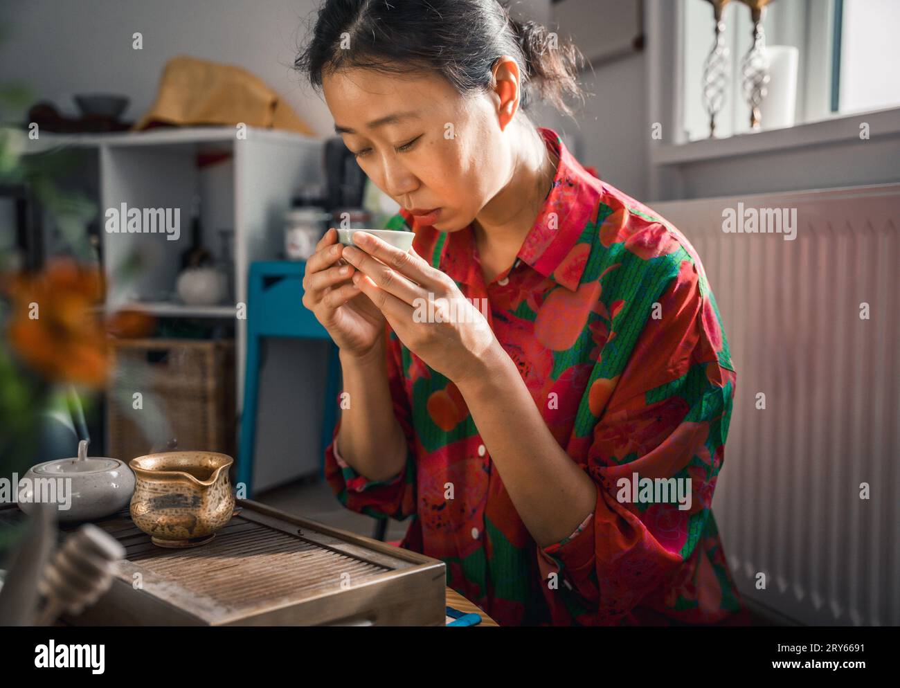 Korean Woman Sipping Tea At Home In Copenhagen, Denmark Stock Photo - Alamy