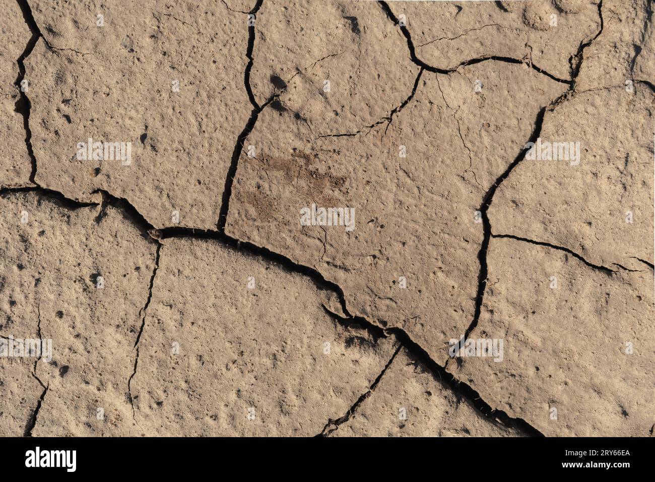 Dry earth in cracks, top view during a drought Stock Photo - Alamy