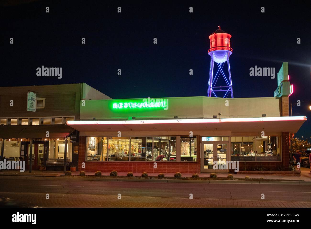 Neon restaurant lights and water tower at night Stock Photo - Alamy