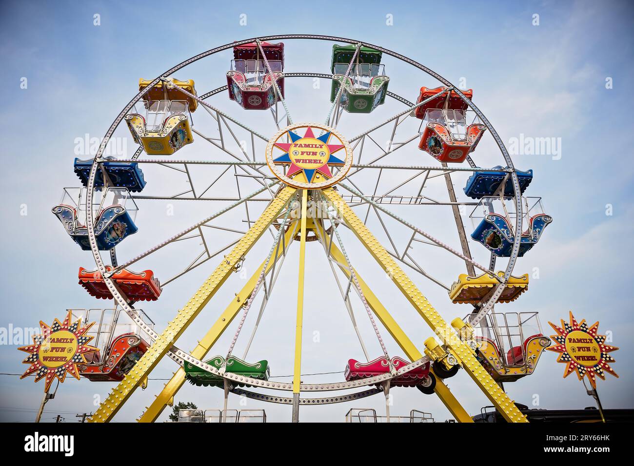 Colorful ferris wheel at carnival against a blue sky Stock Photo - Alamy