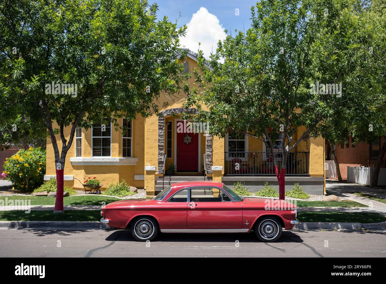 A red vintage car parked in front of suburban home Stock Photo - Alamy