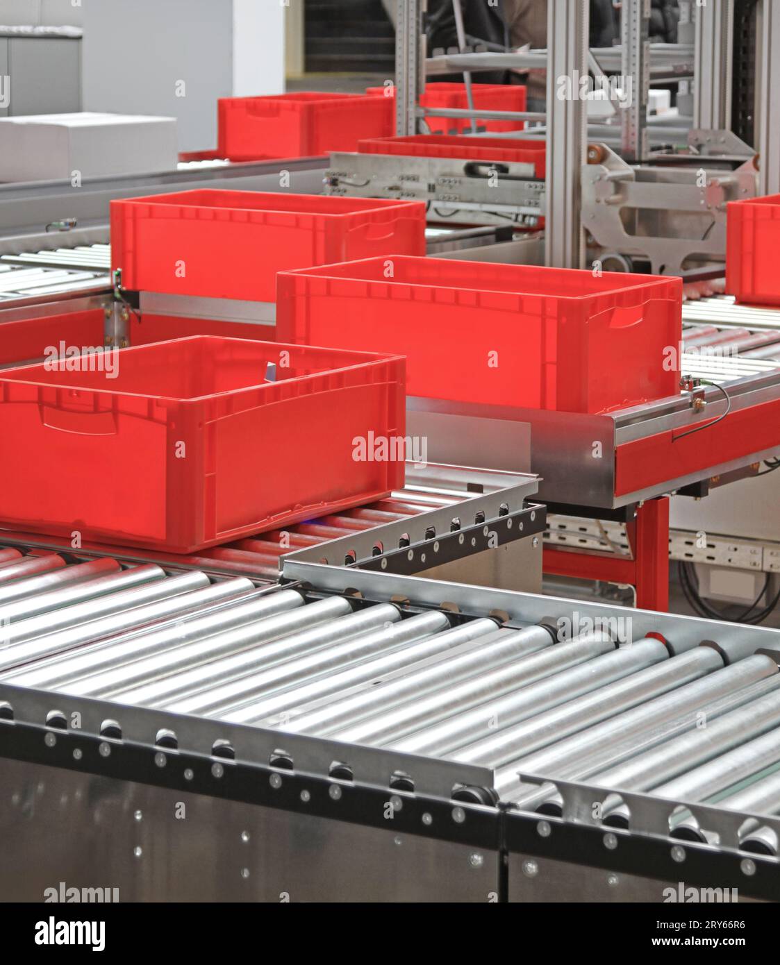 Red Plastic Crates at Conveyor Rollers in Automated Distribution ...