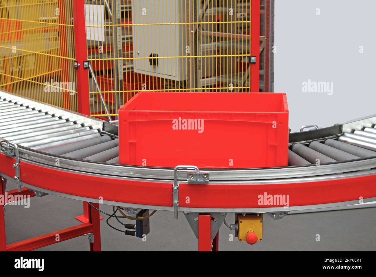 Red crate at conveyor rollers in distribution warehouse hi-res stock ...