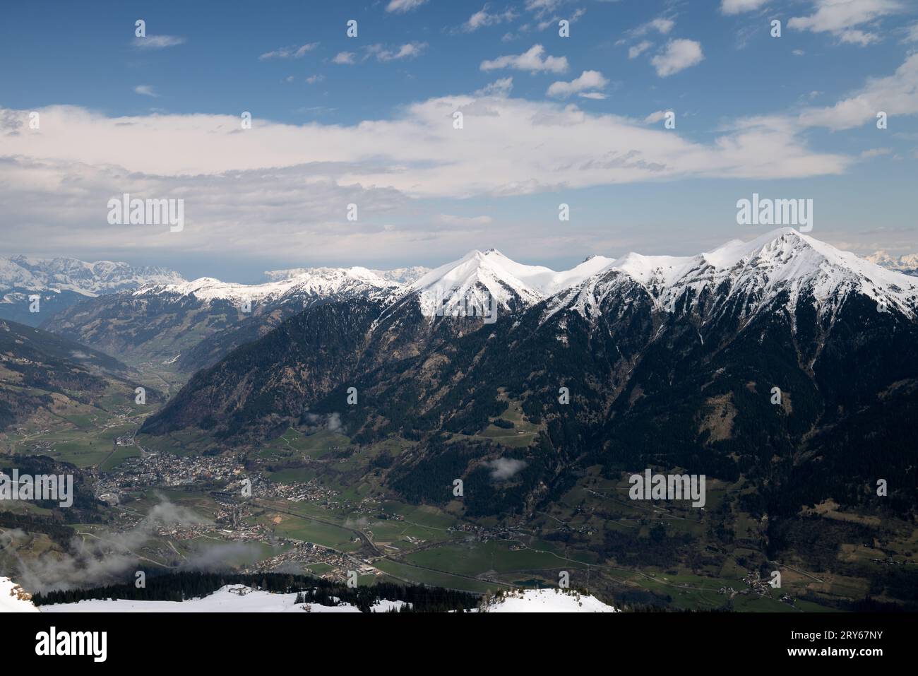 City in the valley of the Alps, snowy peaks of mountains Stock Photo ...