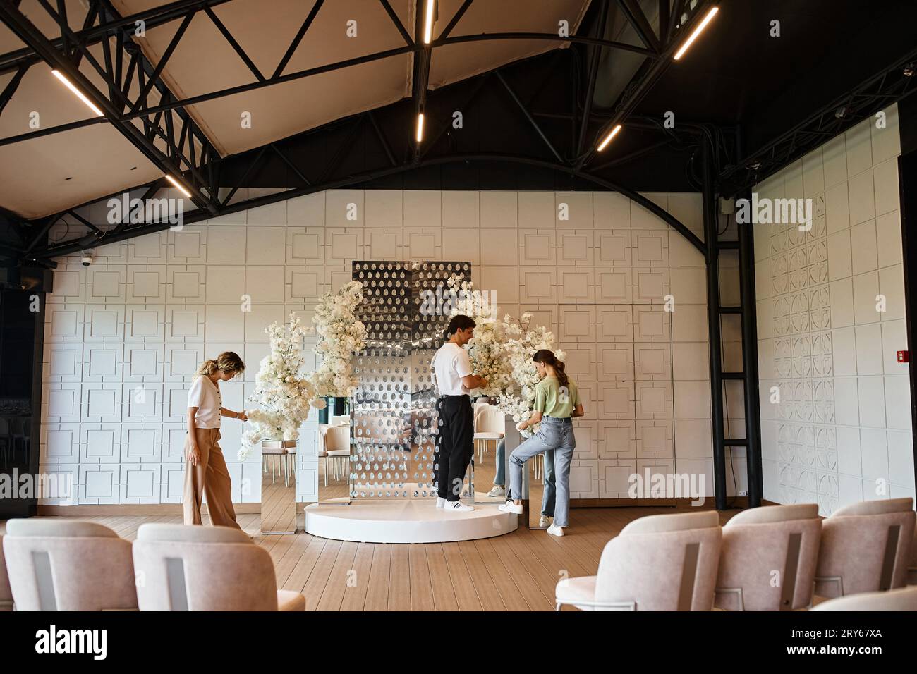 creative team of event designers preparing modern festive hall by ...