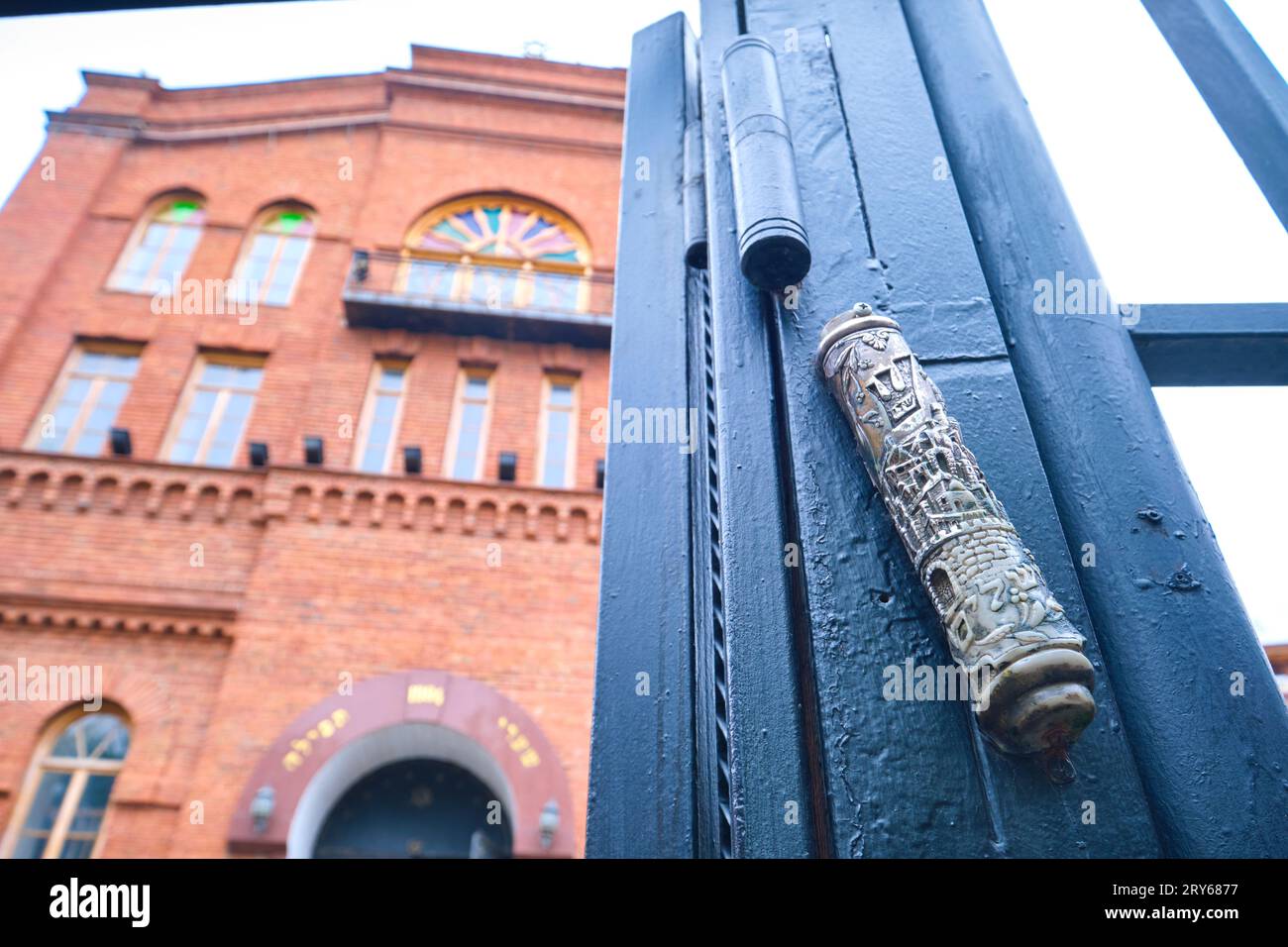 Exterior view with a detail of the silver mezuzah on the front gate. At ...