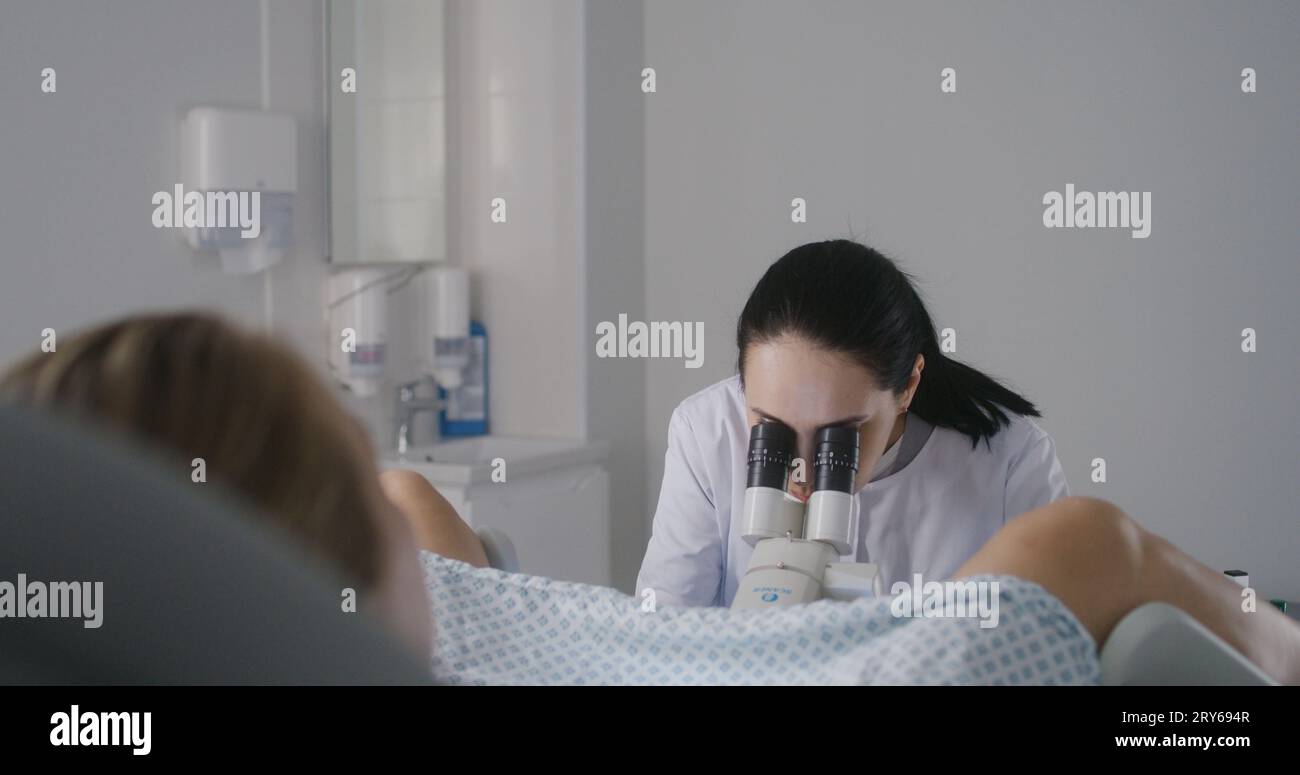 Gynecology room in modern clinic. Female gynecologist uses colposcope ...