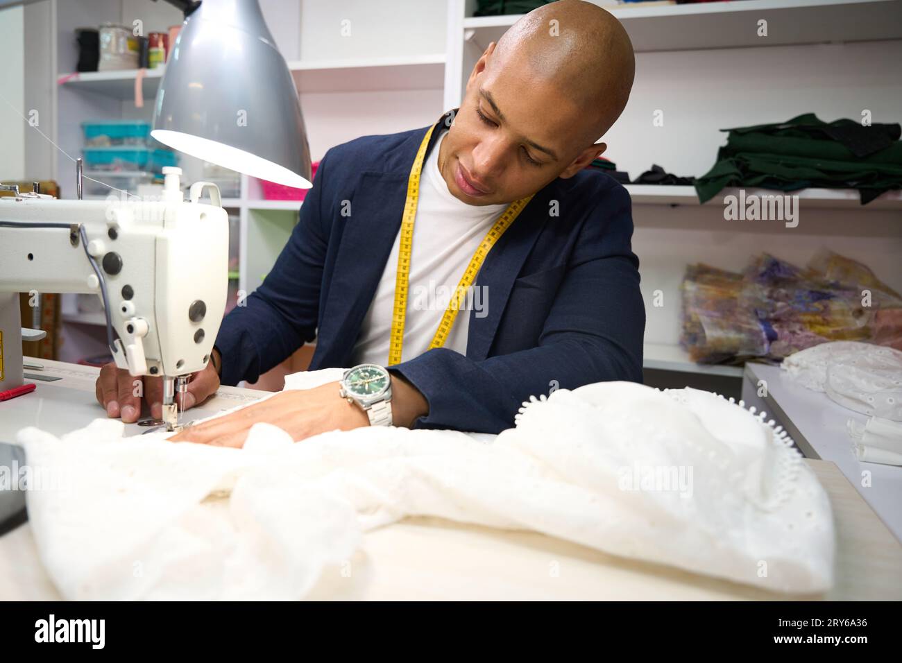 Focused tailor making dress to order in atelier Stock Photo - Alamy