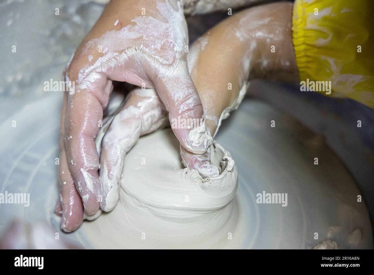 Learning the craft of pottery on the wheel with a dedicated teacher ...