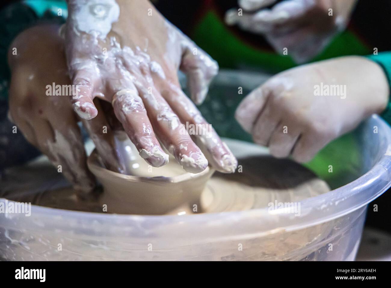 Hands-on instruction from a talented pottery teacher Stock Photo - Alamy