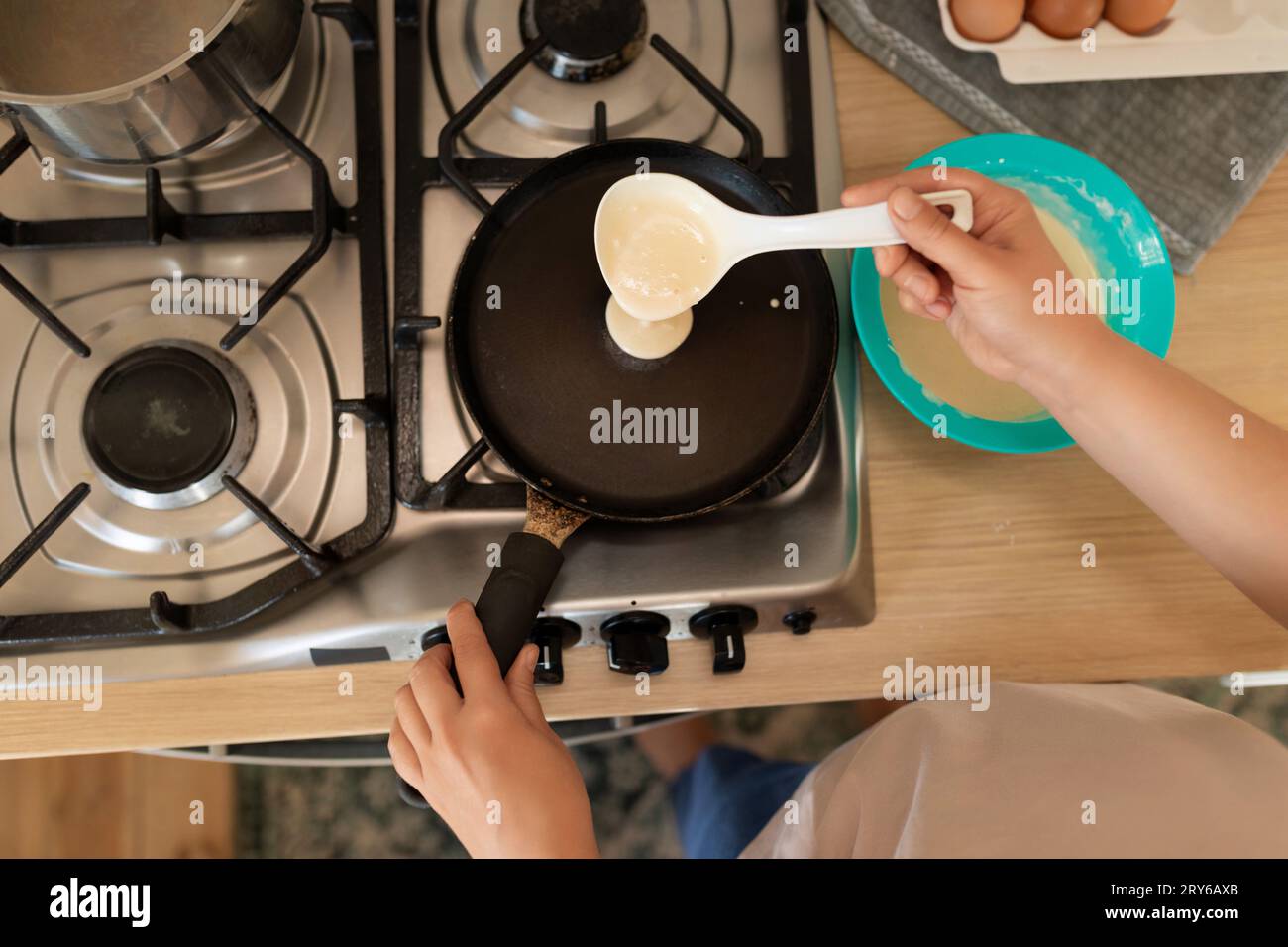 Close-up of a frying pan, gas stove while cooking pancakes Stock Photo ...