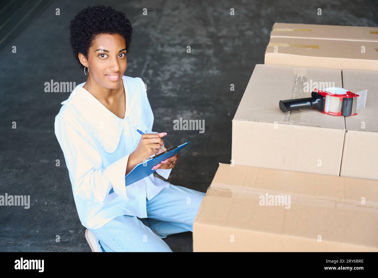 Female makes an inventory of things being deposited Stock Photo - Alamy