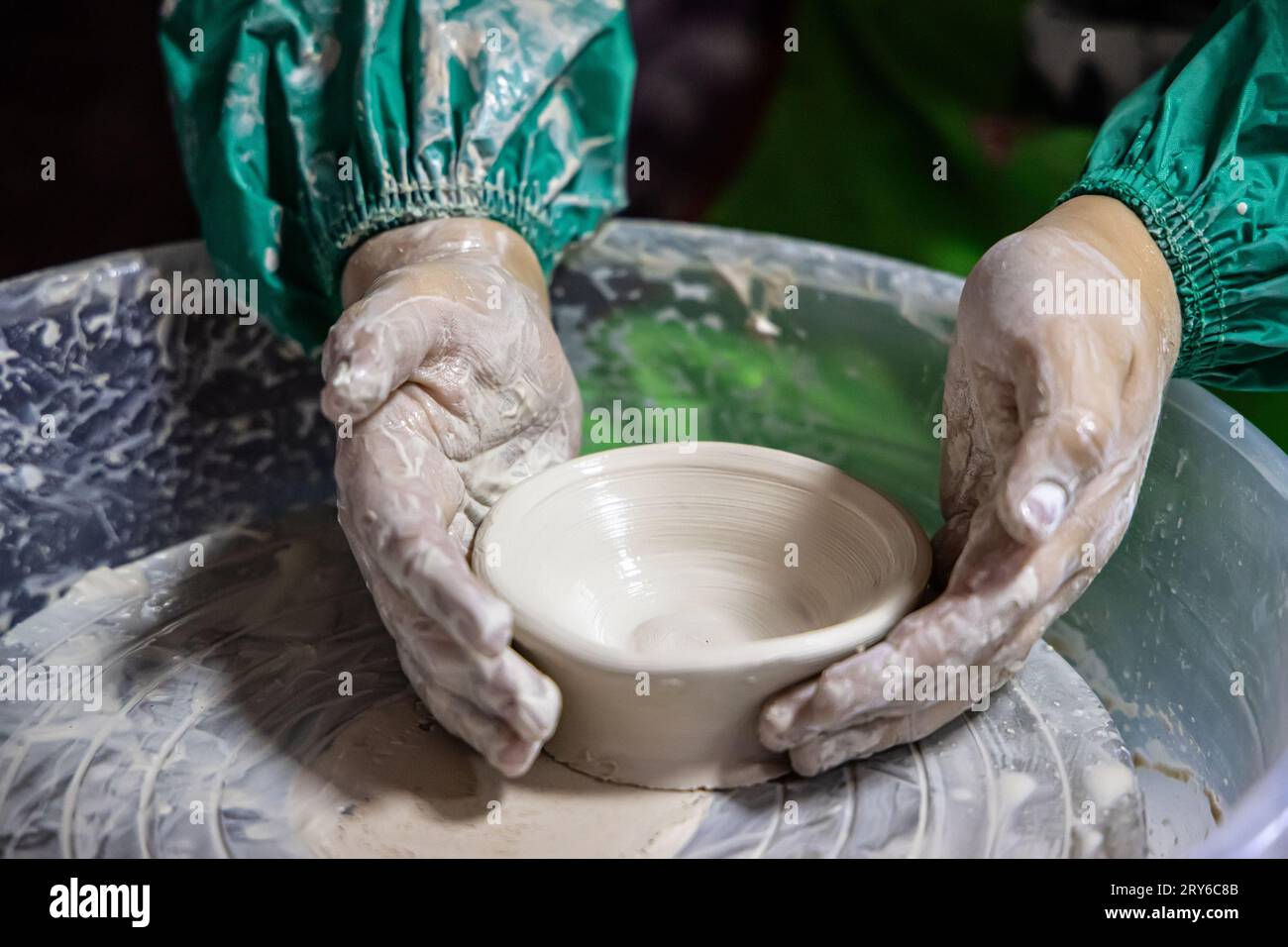 Learning through trial and error as a child attempts to create a clay plate Stock Photo - Alamy