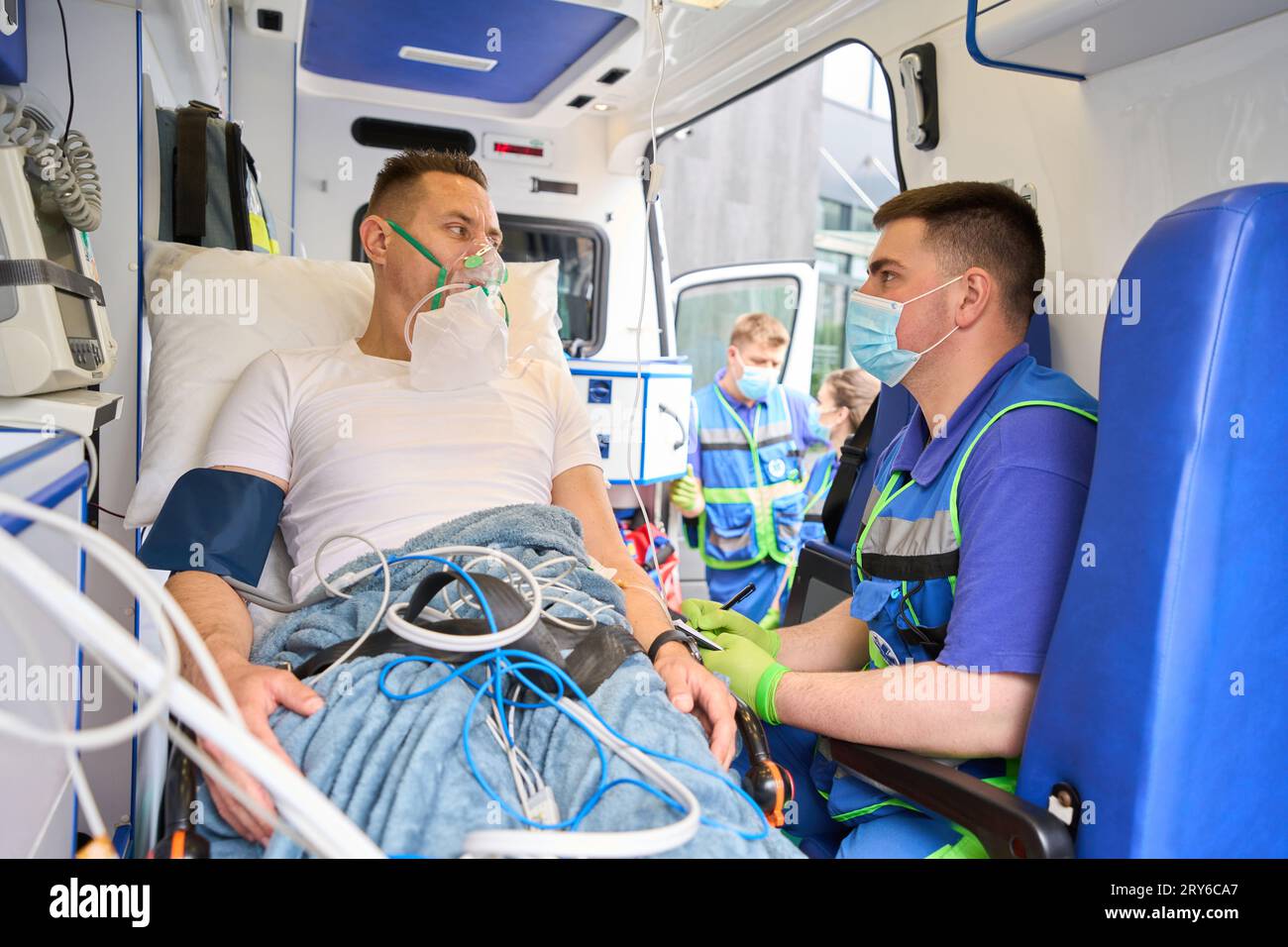 Paramedic records patient responses in ambulance Stock Photo - Alamy