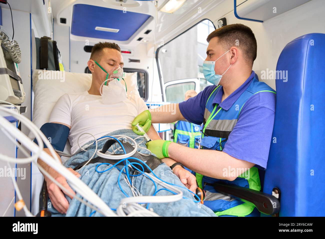 Doctor injecting medicine to patient in ambulance Stock Photo - Alamy