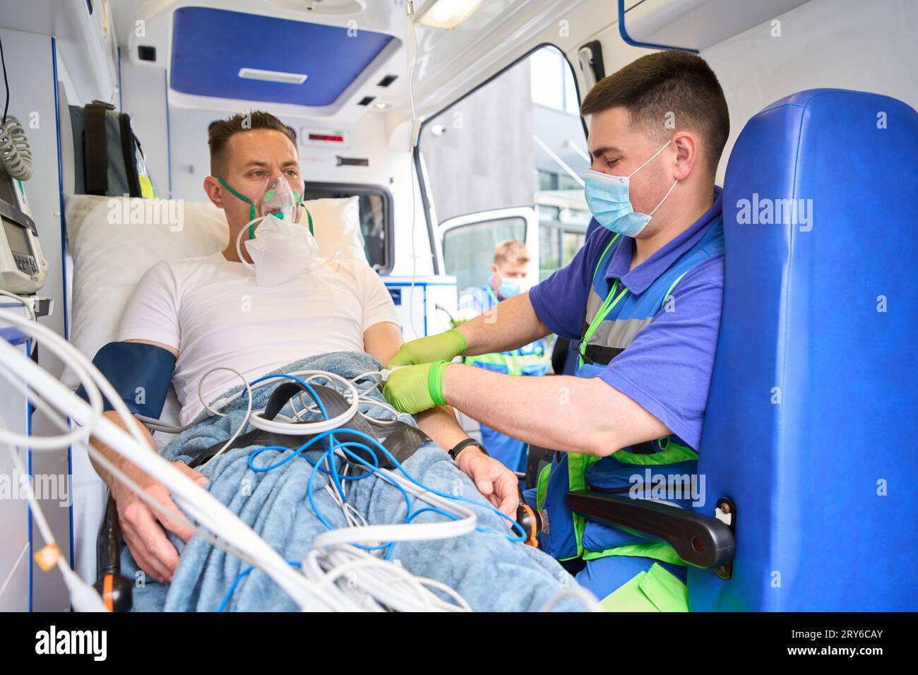 Paramedic administering medicine to a patient in an ambulance Stock ...