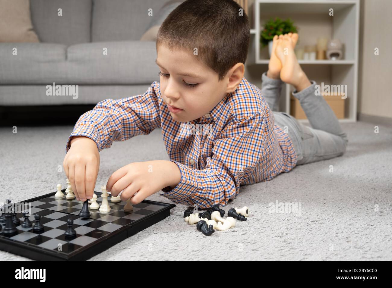Little boy playing chess. Board games for children Stock Photo - Alamy