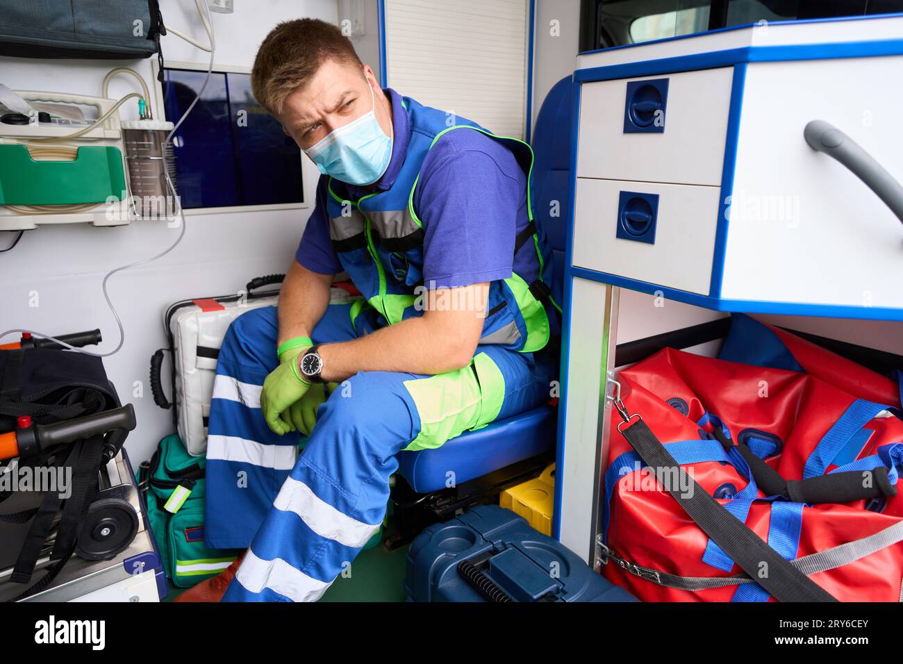 Paramedic in a protective mask is in an ambulance Stock Photo - Alamy