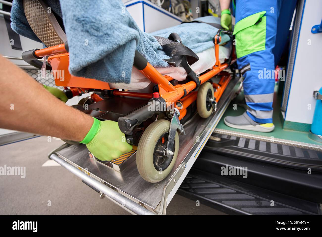 Loading a stretcher with a patient into an ambulance Stock Photo - Alamy