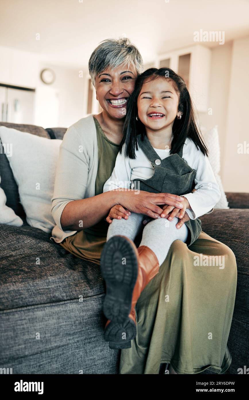 Portrait, care and grandmother with child on sofa together for bonding ...