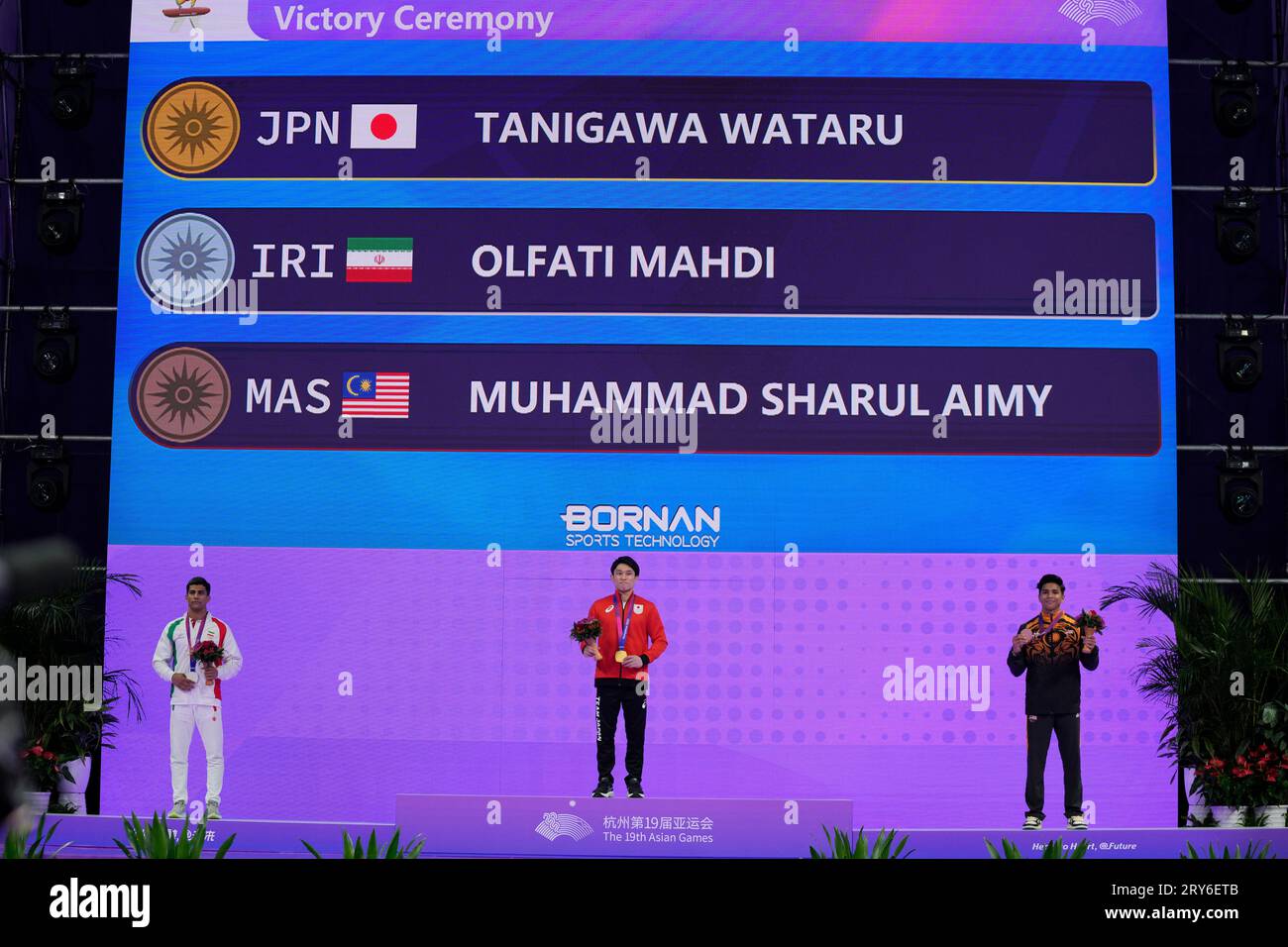 Gold medalist Japan's Wataru Tanigawa, center, silver medalist Iran's Mahdi Olfati, left, and ...