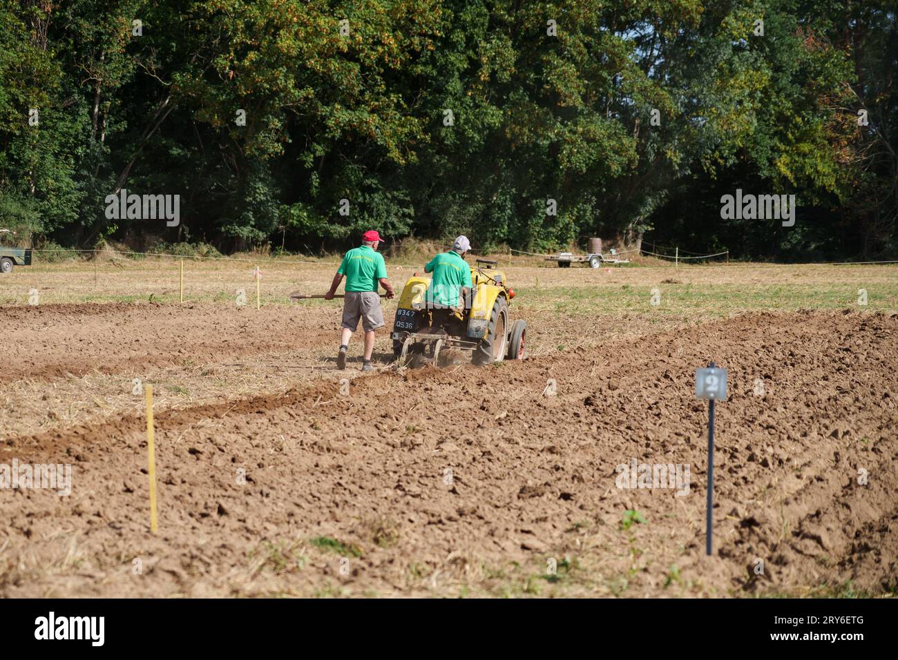 Competitors on vintage farm machinery taking place in a ploughing ...