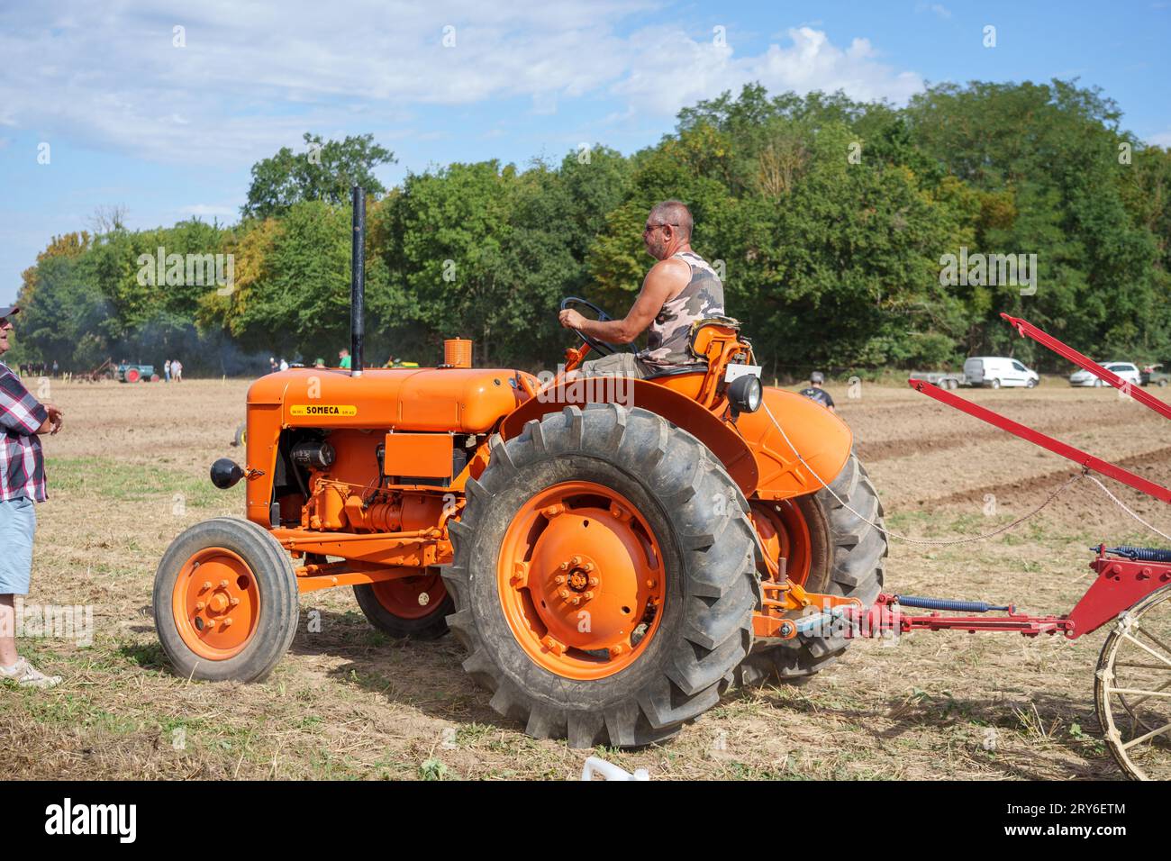 Competitors on vintage farm machinery taking place in a ploughing ...