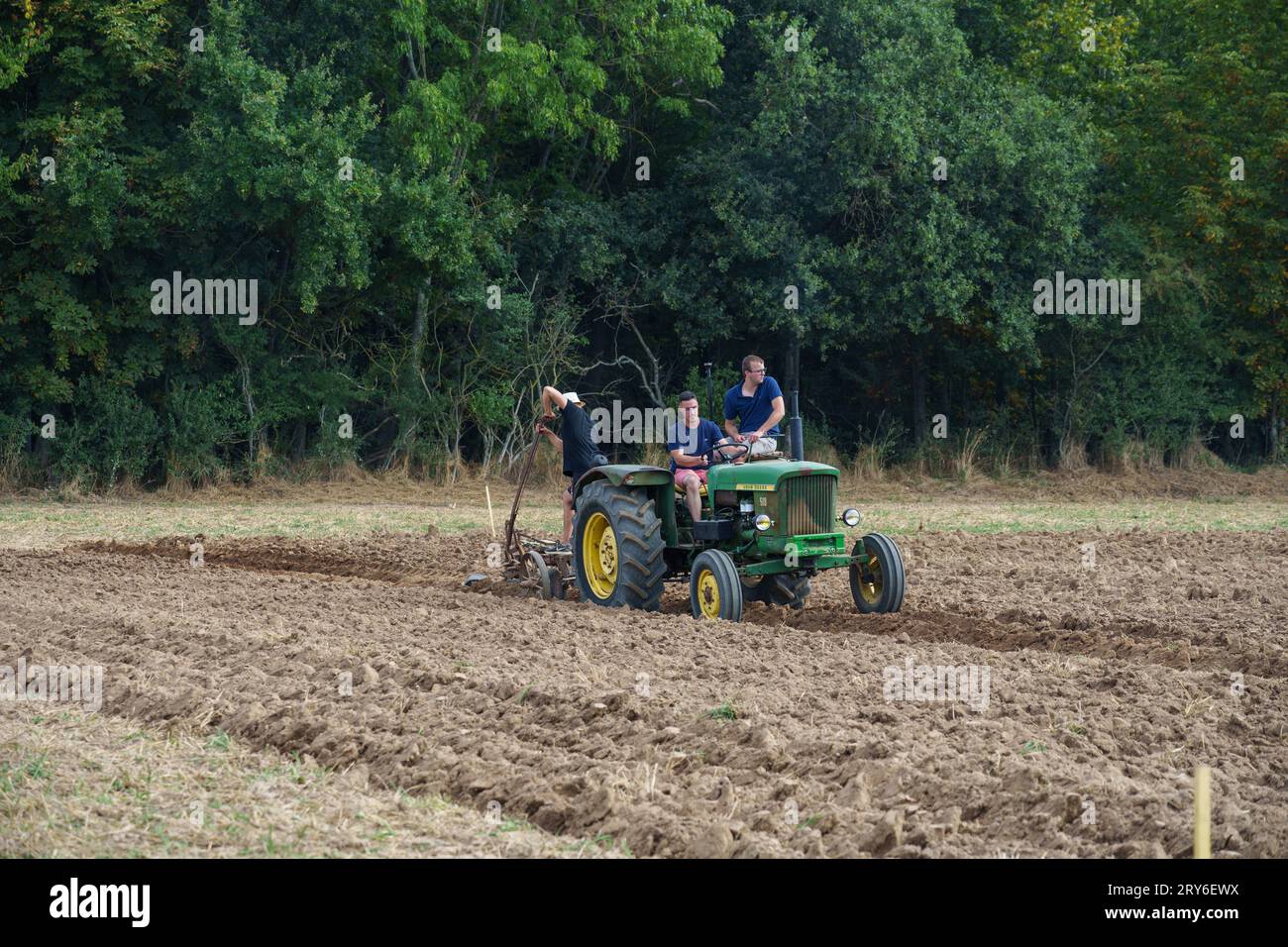 Competitors on vintage farm machinery taking place in a ploughing ...