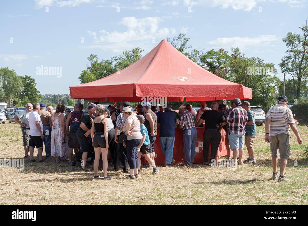 Farmers gather around the bar at a harvest festival Stock Photo - Alamy