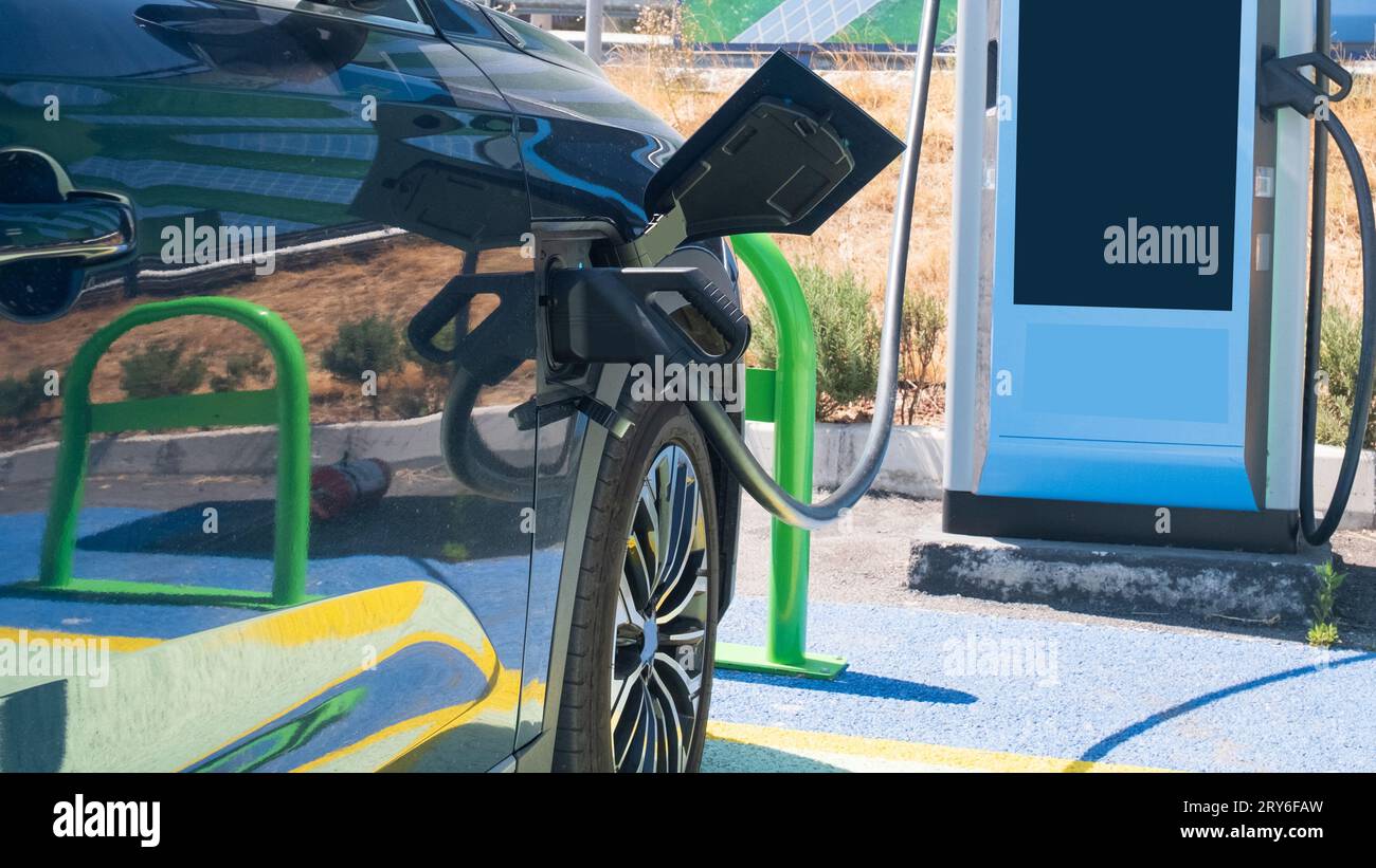 Power cable pump plug in charging power to electric vehicle EV car with ...